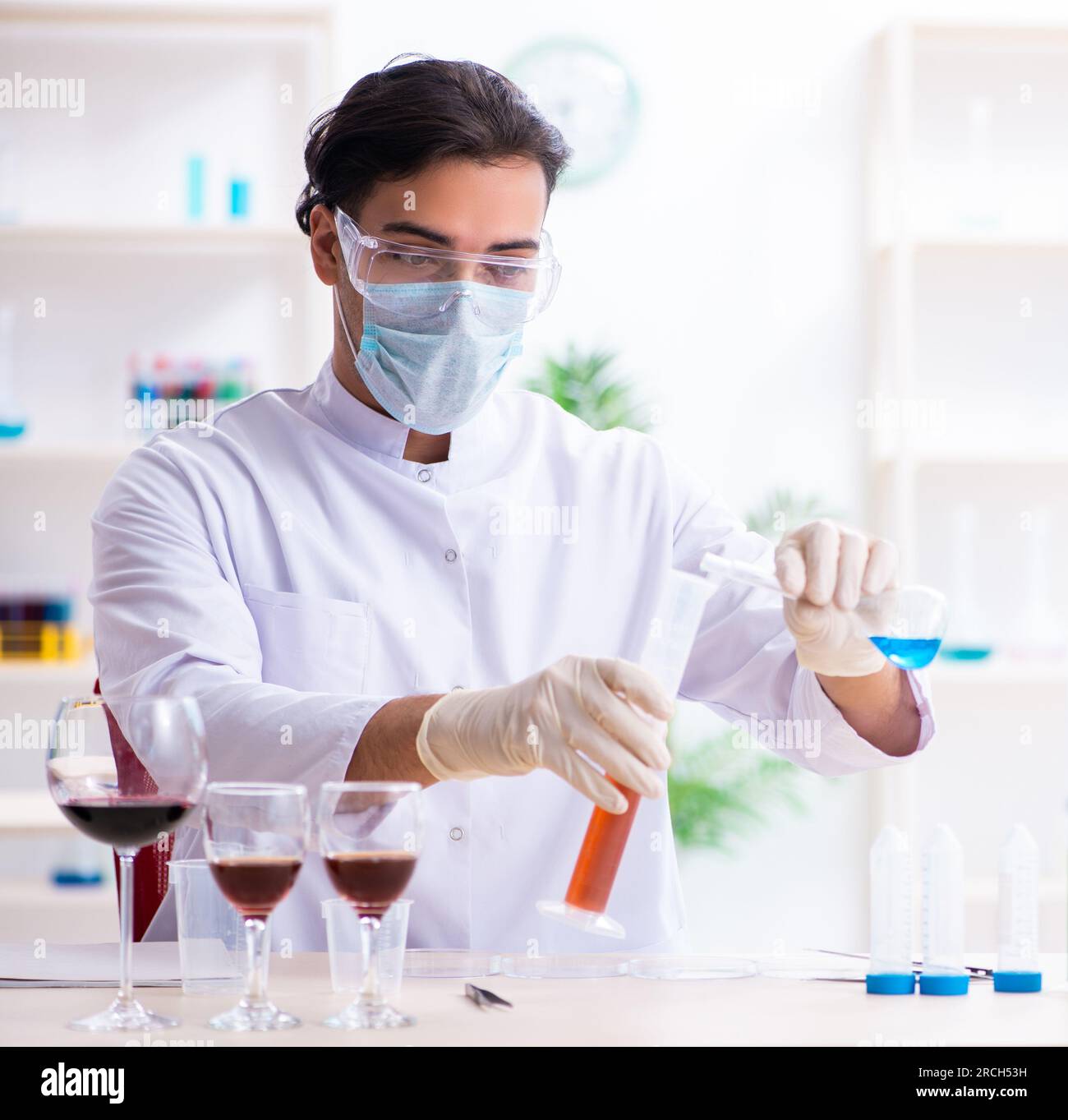 The male chemist examining wine samples at lab Stock Photo - Alamy