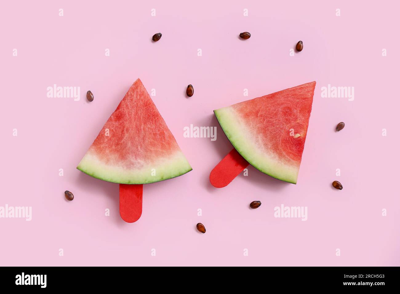 Sweet watermelon sticks and seeds on pink background Stock Photo - Alamy
