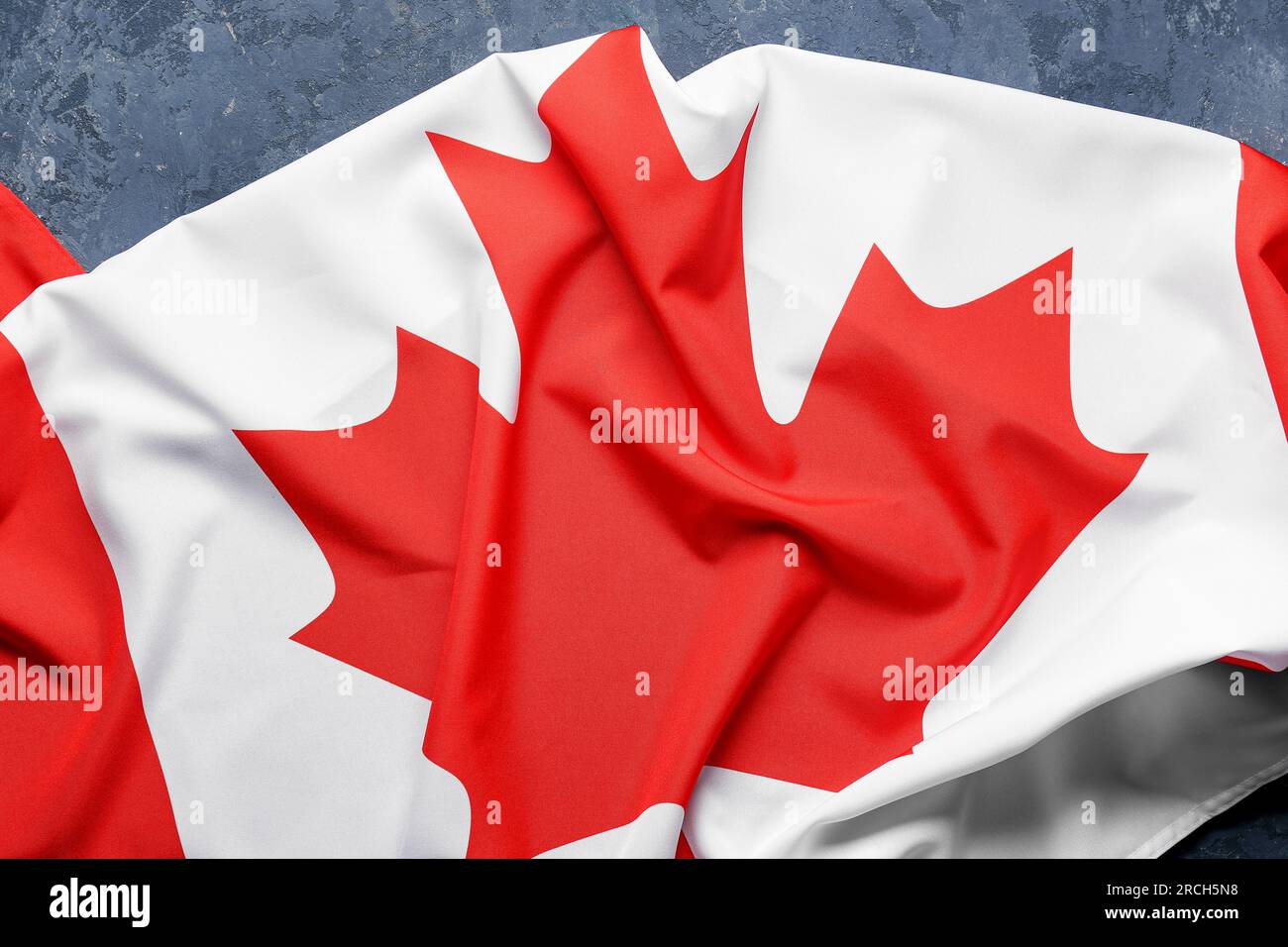 Flag of Canada on blue background Stock Photo - Alamy