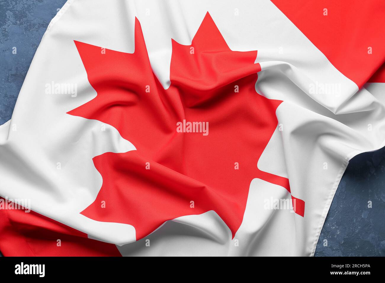 Flag of Canada on blue background Stock Photo - Alamy