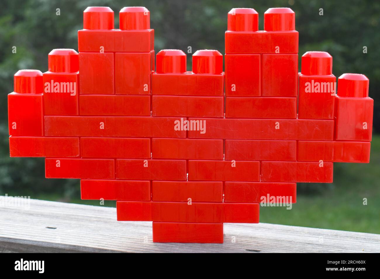 Bright red heart made out of large connecting blocks, Legos, sitting on ...
