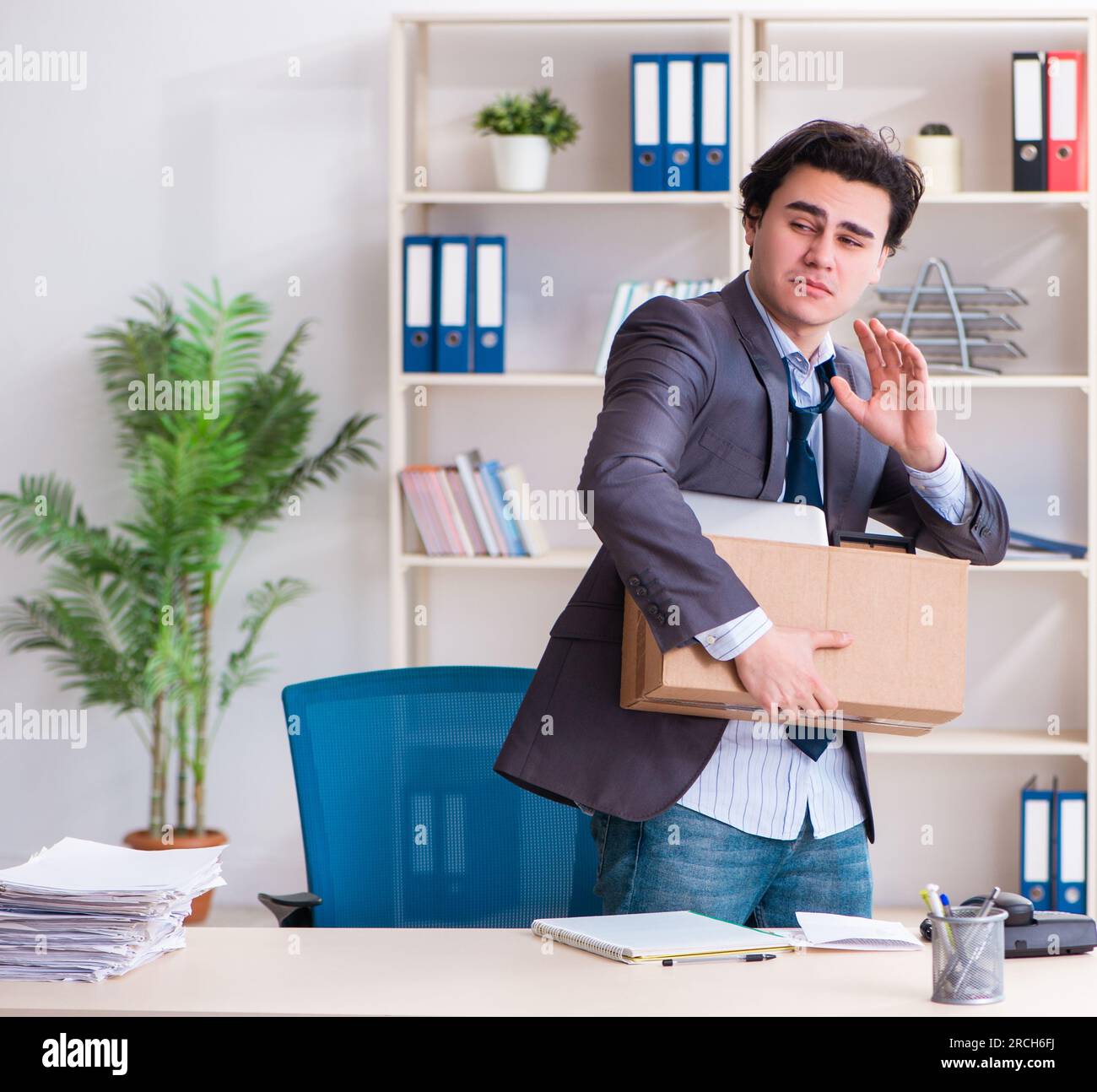 The young male employee being fired from his work Stock Photo - Alamy
