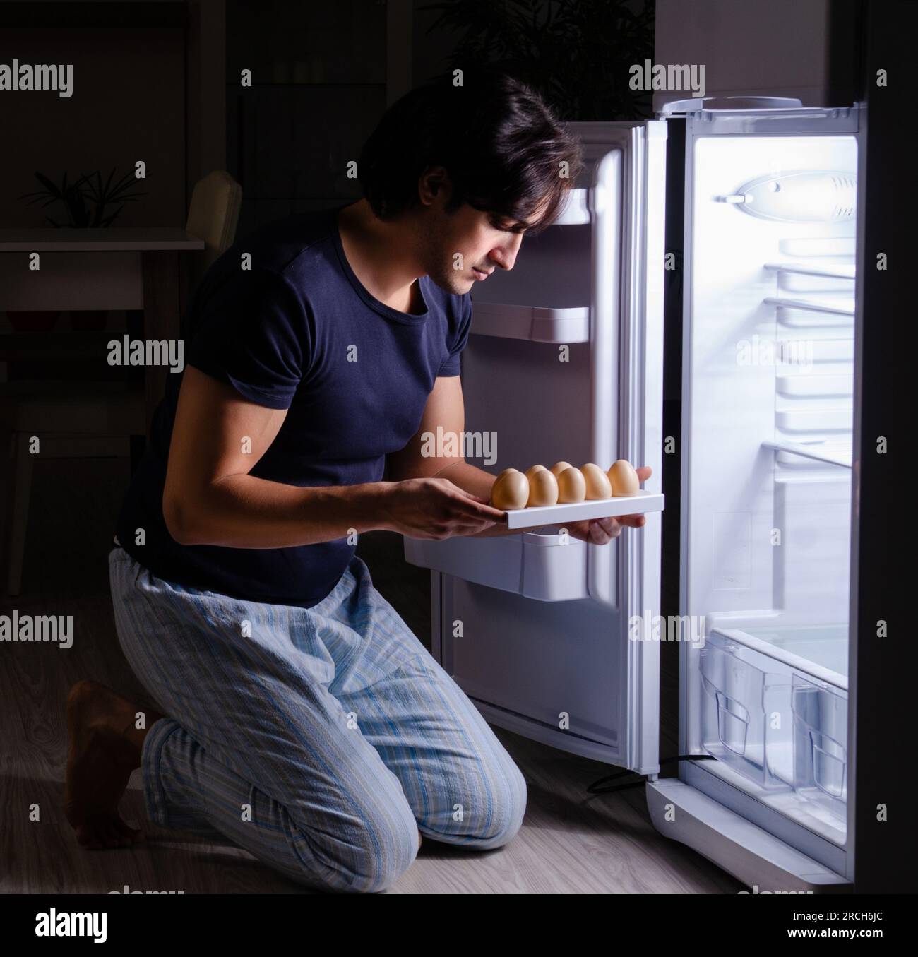 Young man fridge opening night hi-res stock photography and images - Alamy