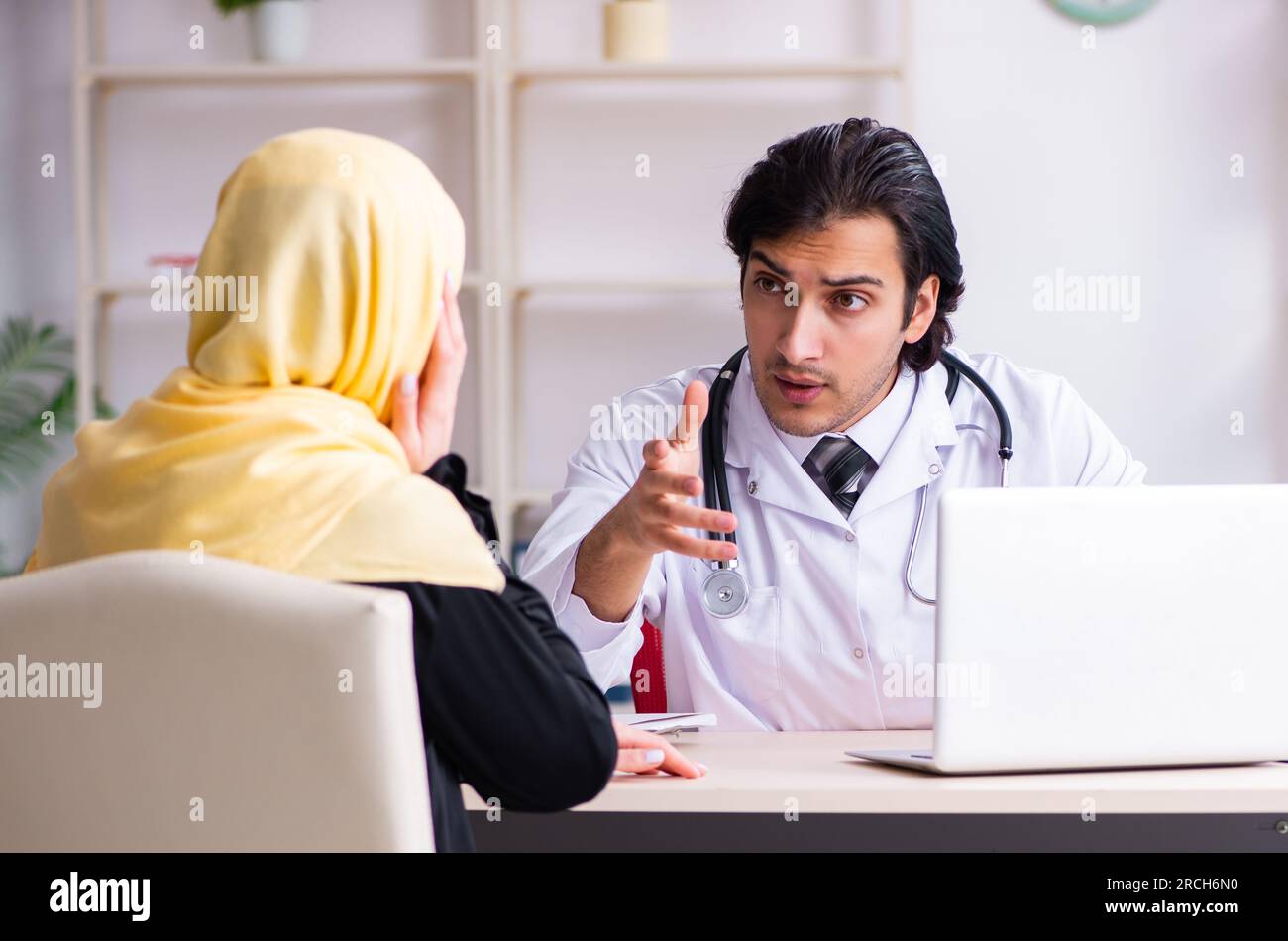 The female arab patient visiting male doctor Stock Photo - Alamy