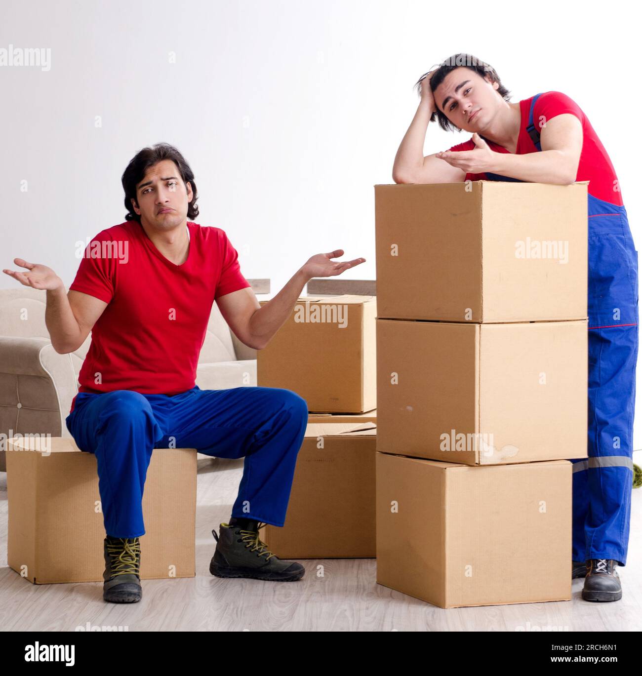 The two young contractor employees moving personal belongings Stock ...