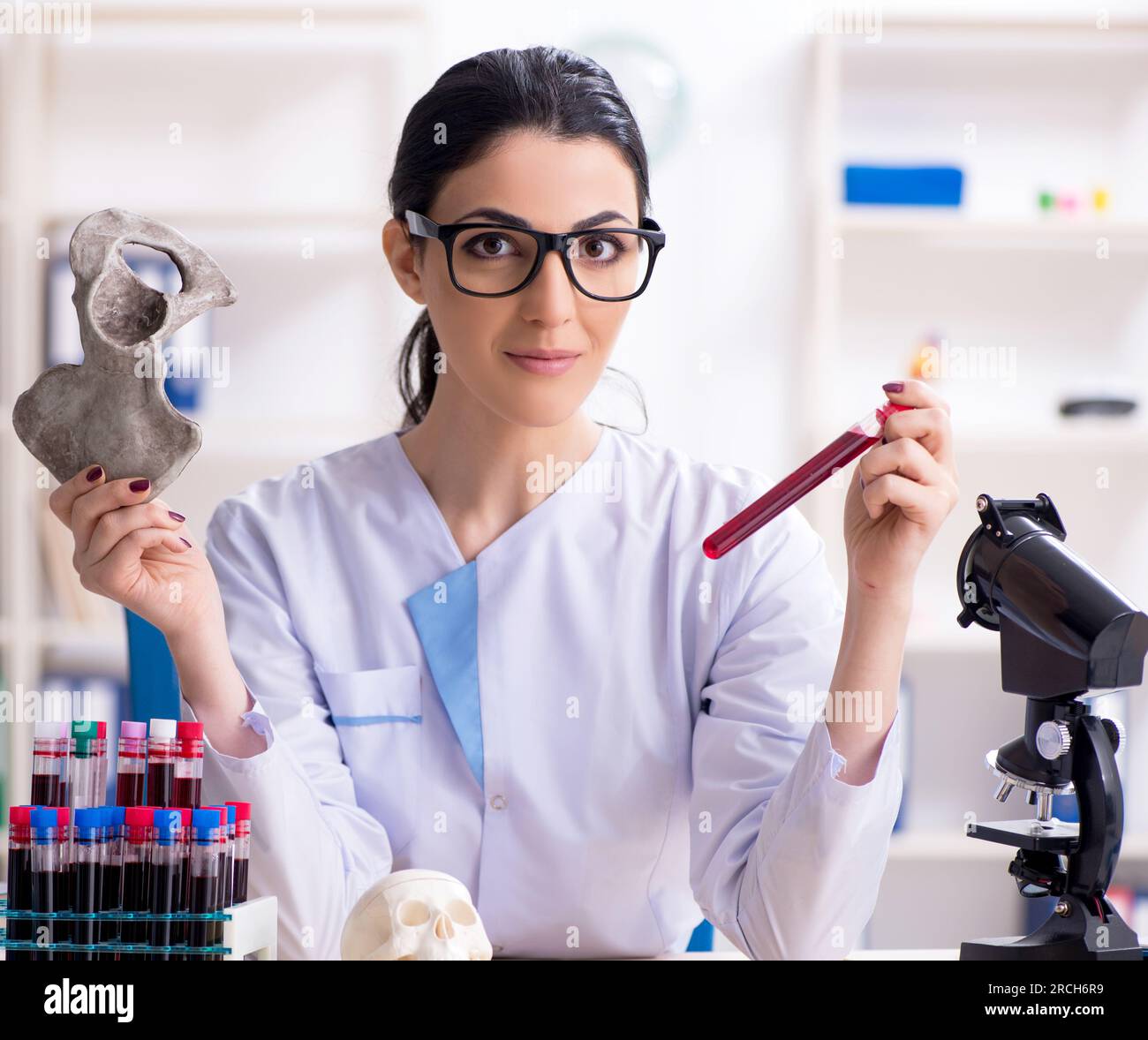 The young female archaeologist working in the lab Stock Photo - Alamy