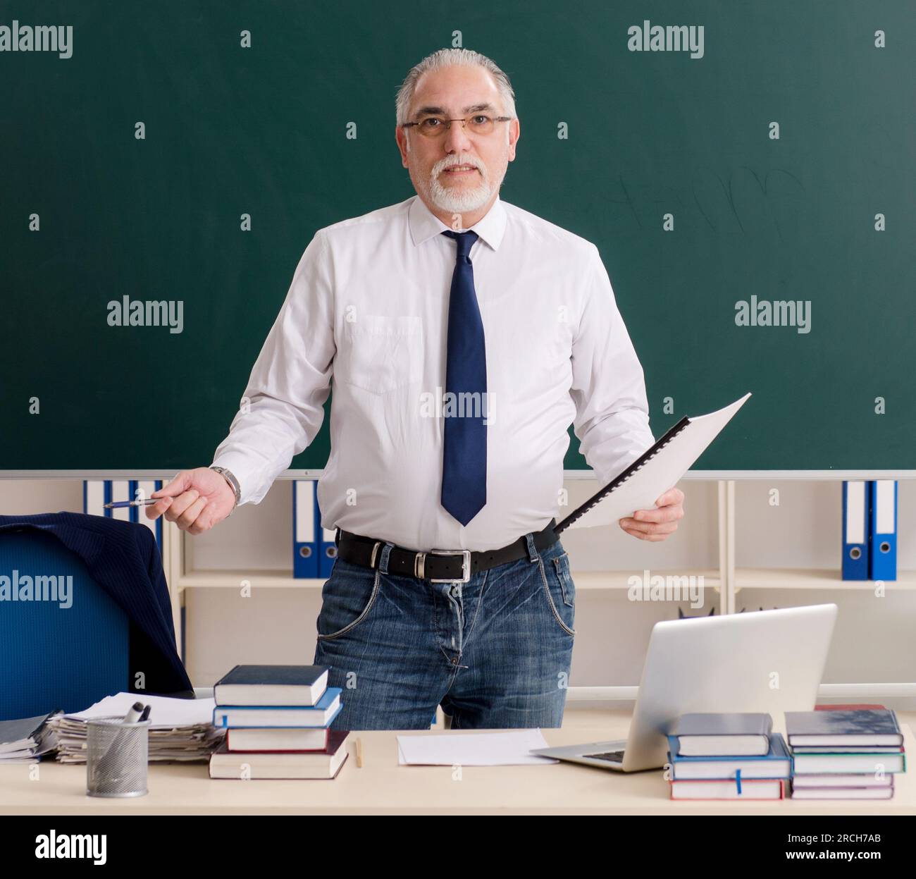 The aged male teacher in front of chalkboard Stock Photo - Alamy