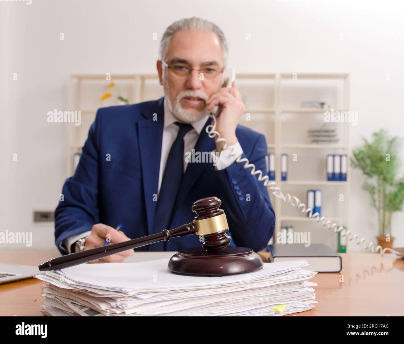 The aged lawyer working in the courthouse Stock Photo - Alamy