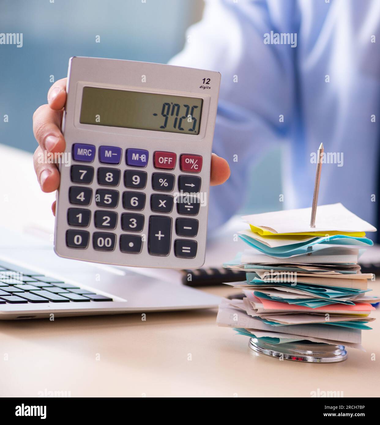 Bank employee showing calculator hi-res stock photography and images ...