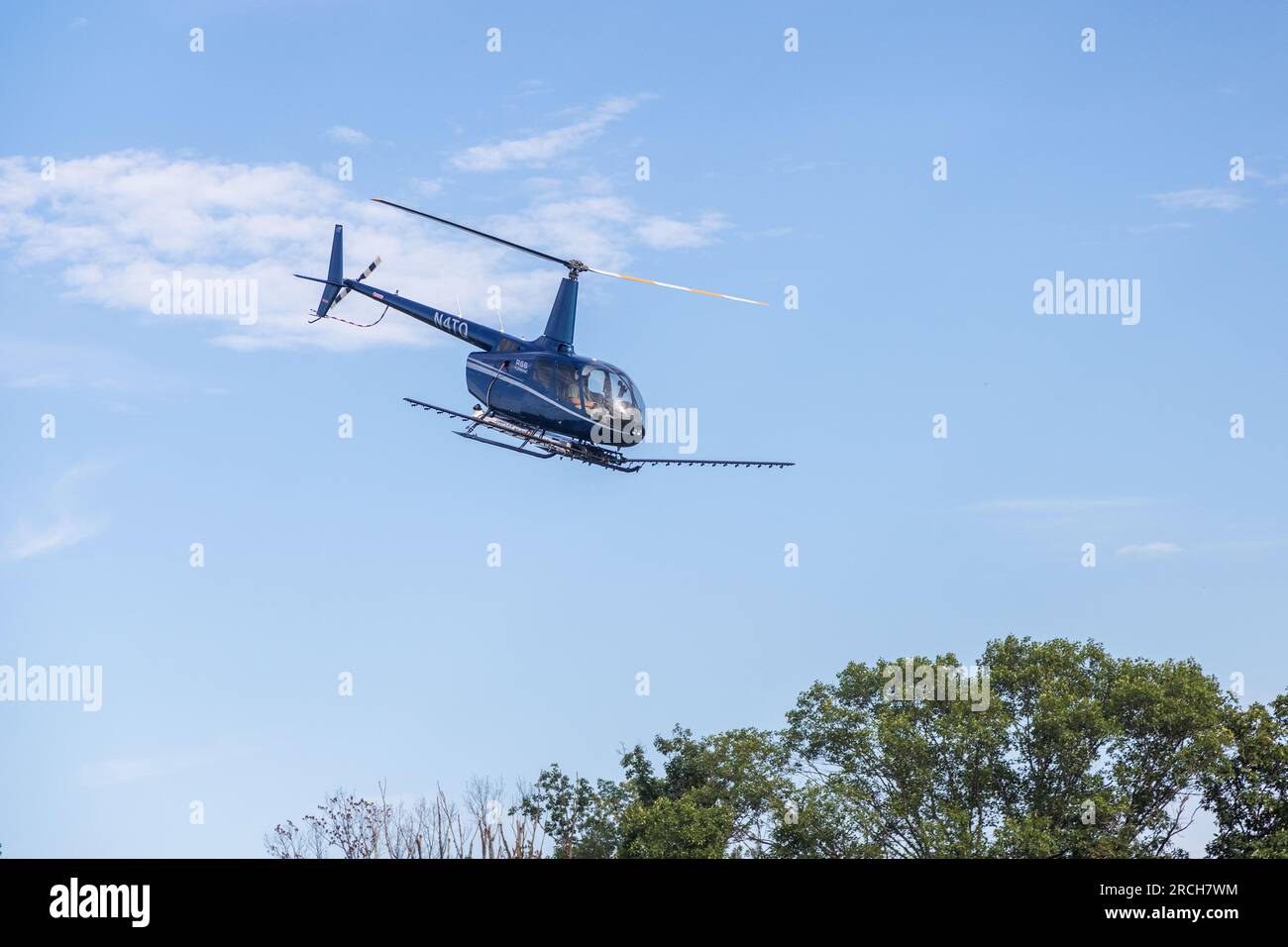 A Robinson R66 crop dusting helicopter from Black Nine Aerial of East ...