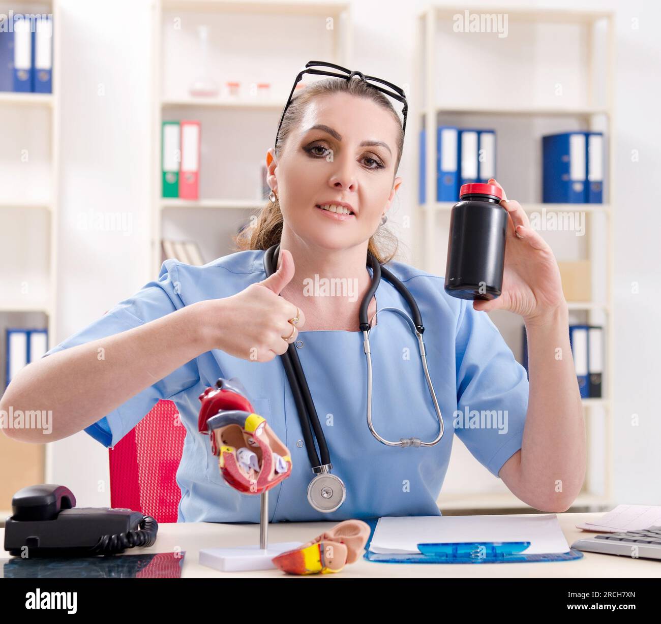 The female doctor cardiologist working in the clinic Stock Photo - Alamy