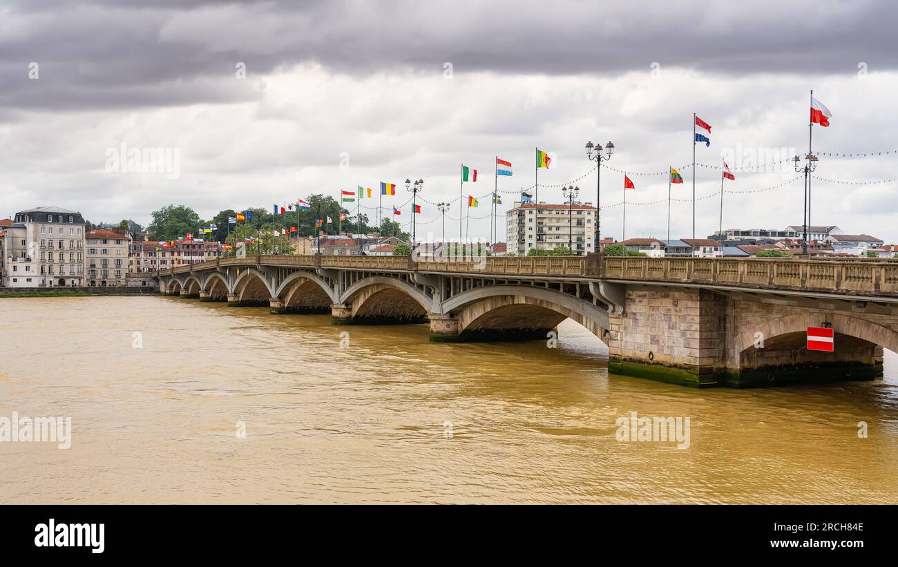 Large bridge with flags of various countries that crosses the river of ...