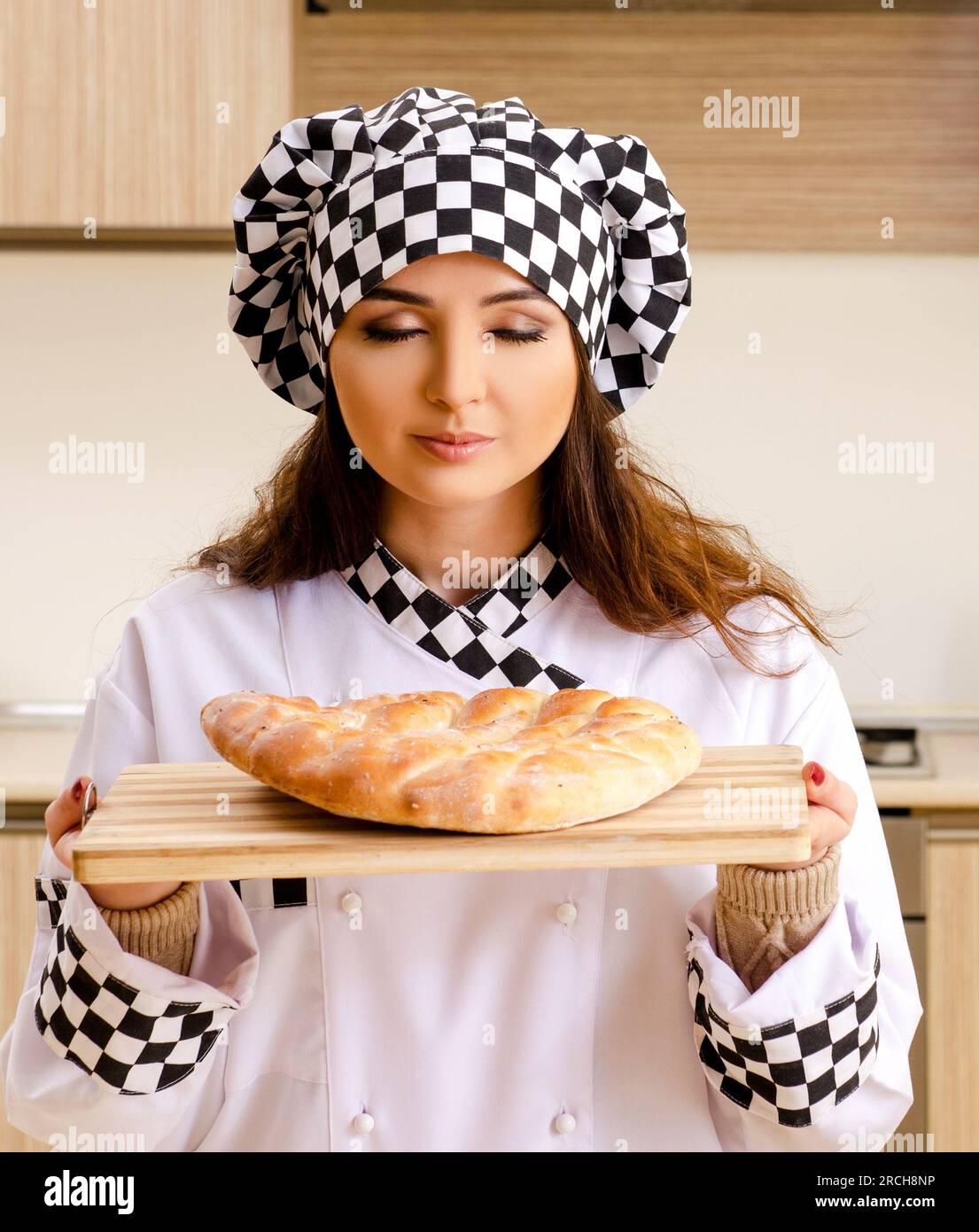 The young female baker working in kitchen Stock Photo - Alamy