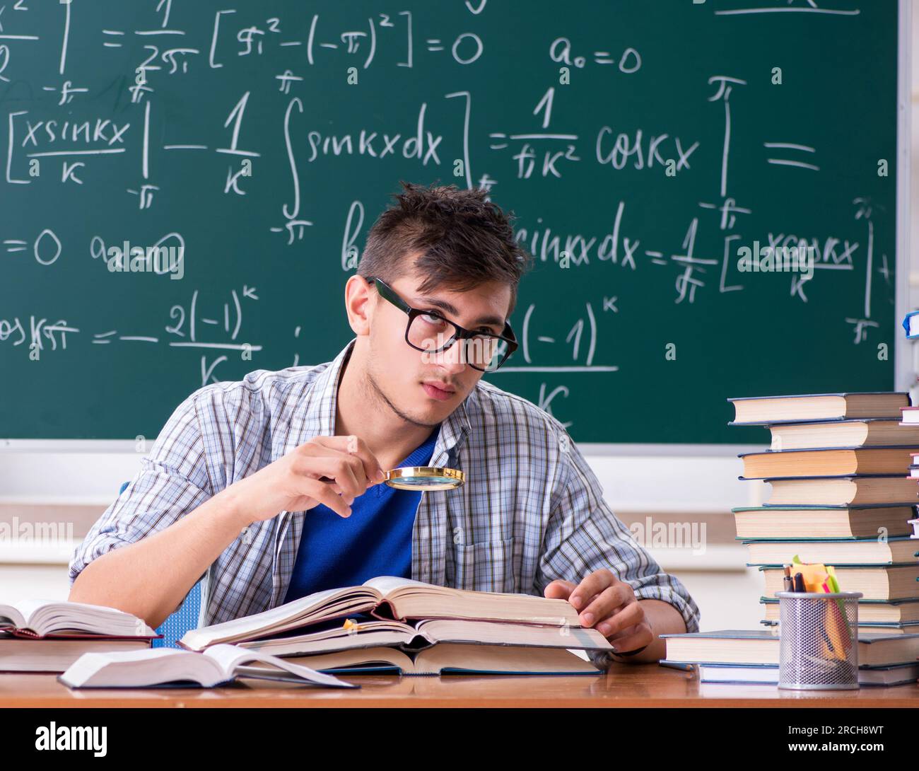 The young male student studying math at school Stock Photo - Alamy