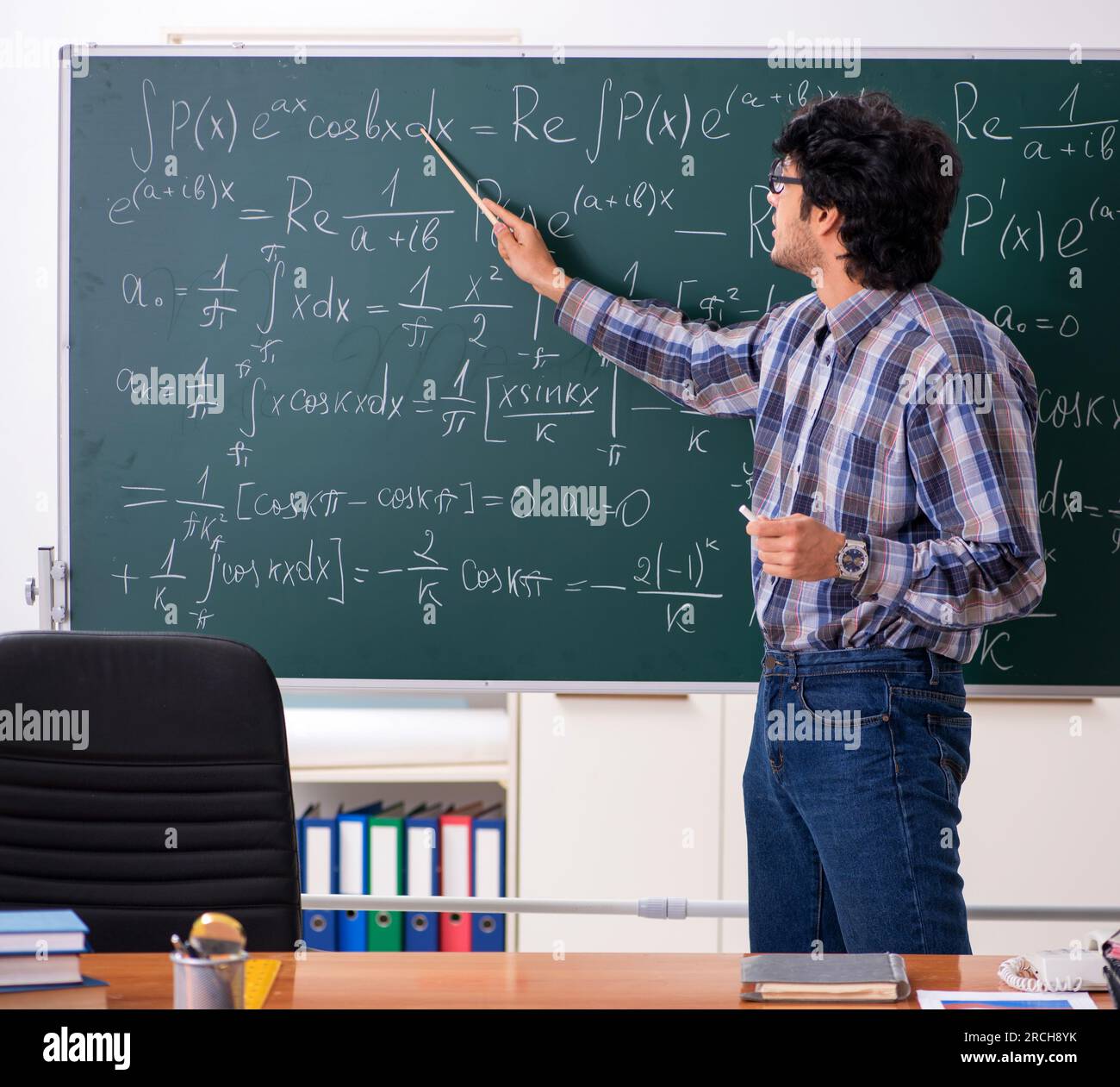 The funny male math teacher in the classroom Stock Photo - Alamy