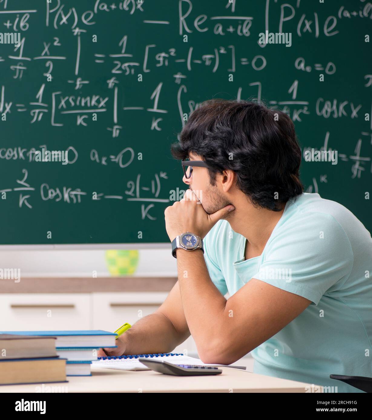 The young male student mathematician in front of chalkboard Stock Photo ...