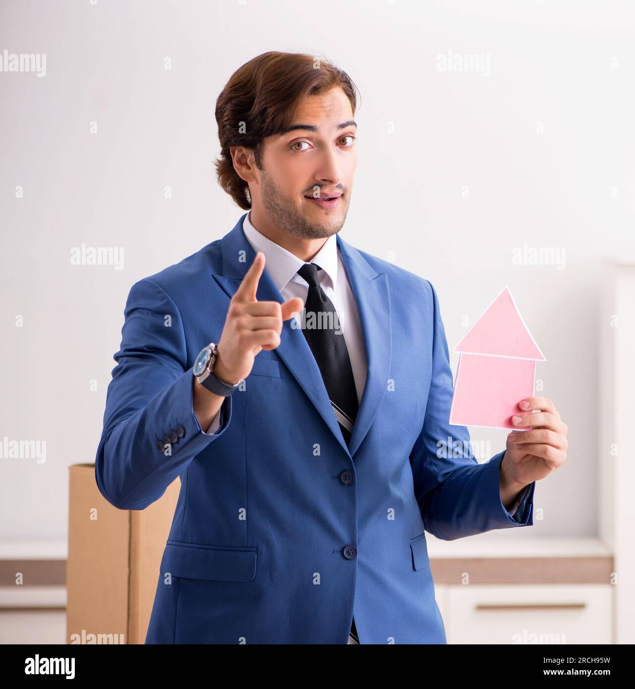 The young handsome realtor selling flat Stock Photo - Alamy