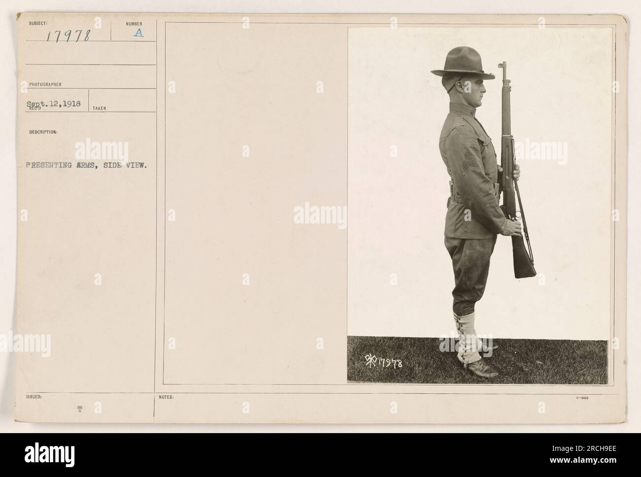 Soldiers standing at attention and presenting arms. The photograph ...
