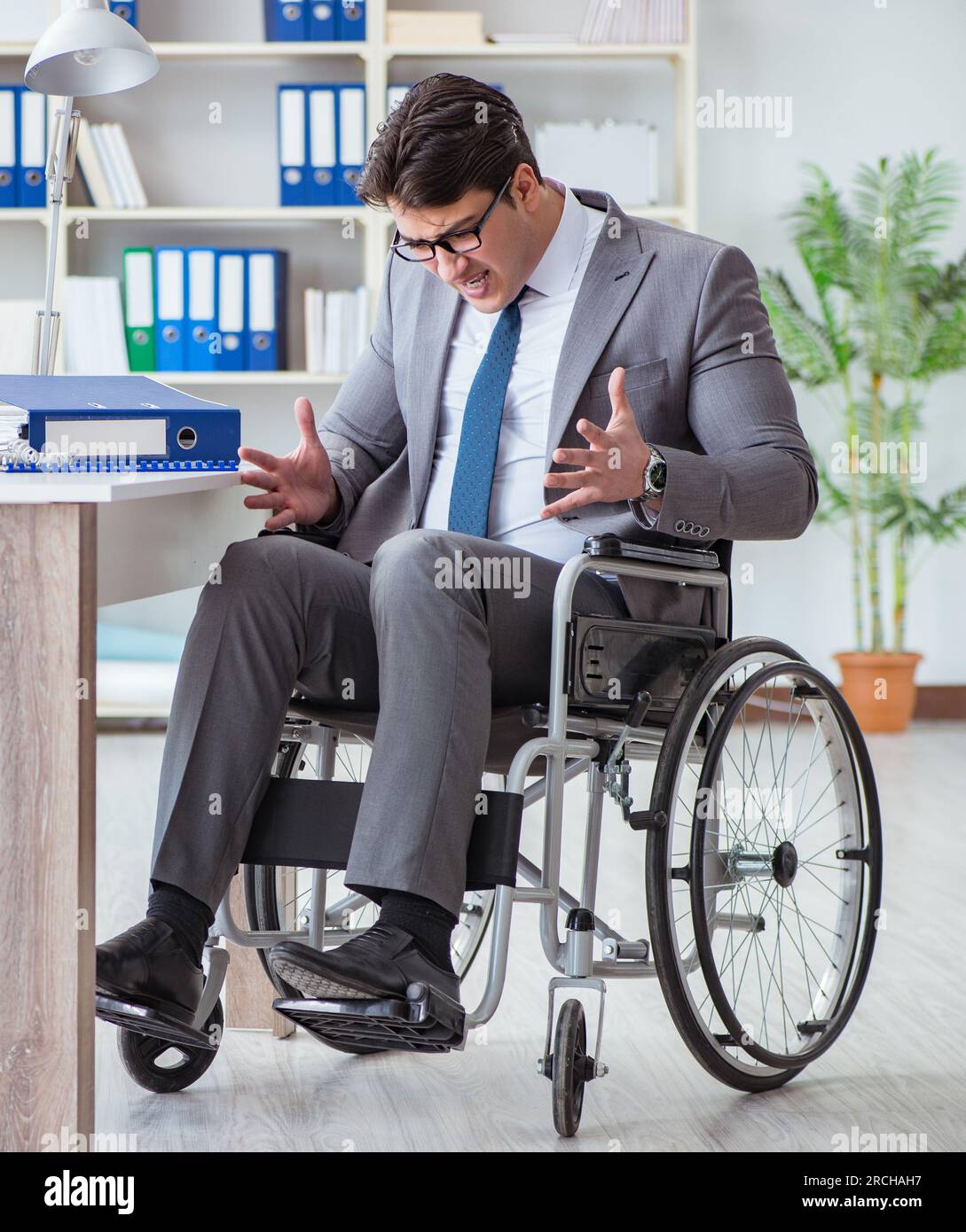 The disabled businessman working in the office Stock Photo - Alamy