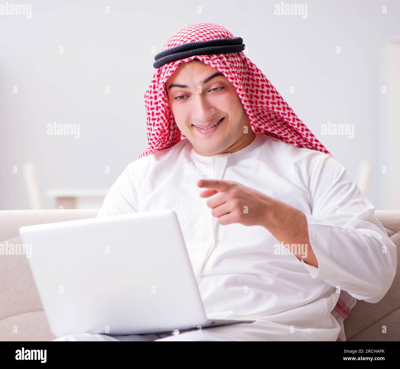 The young arab businessman working with laptop on sofa Stock Photo - Alamy