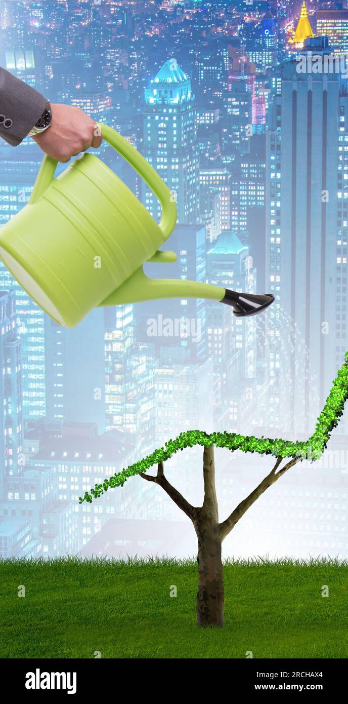The businessman in investment concept watering financial line chart ...