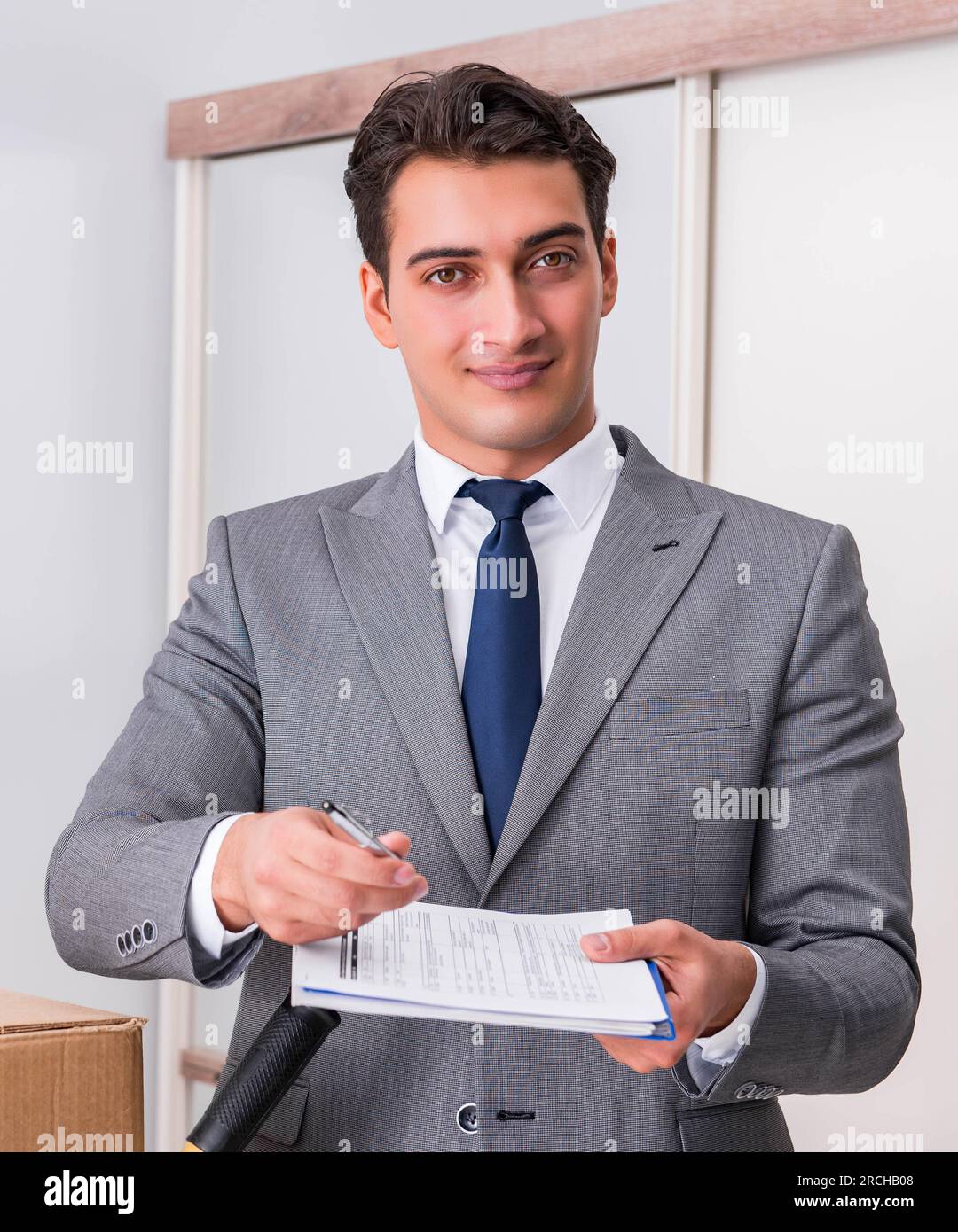 The man signing for the delivery of boxes Stock Photo - Alamy