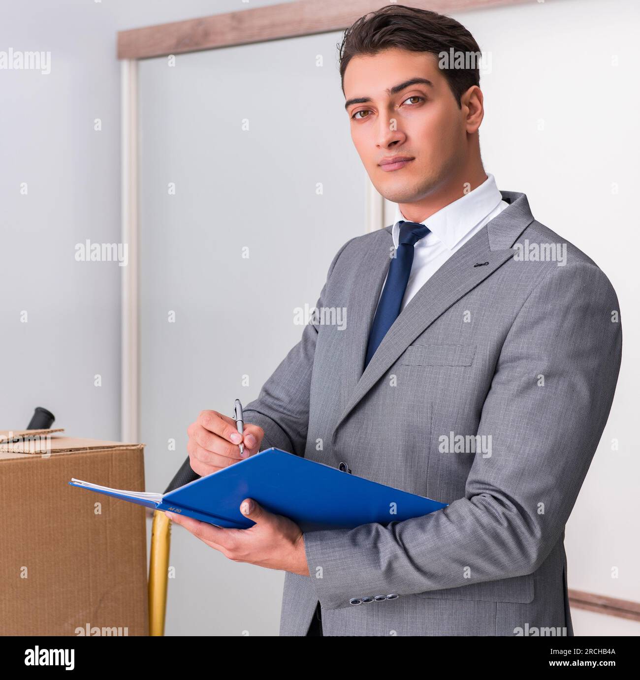 The man signing for the delivery of boxes Stock Photo - Alamy