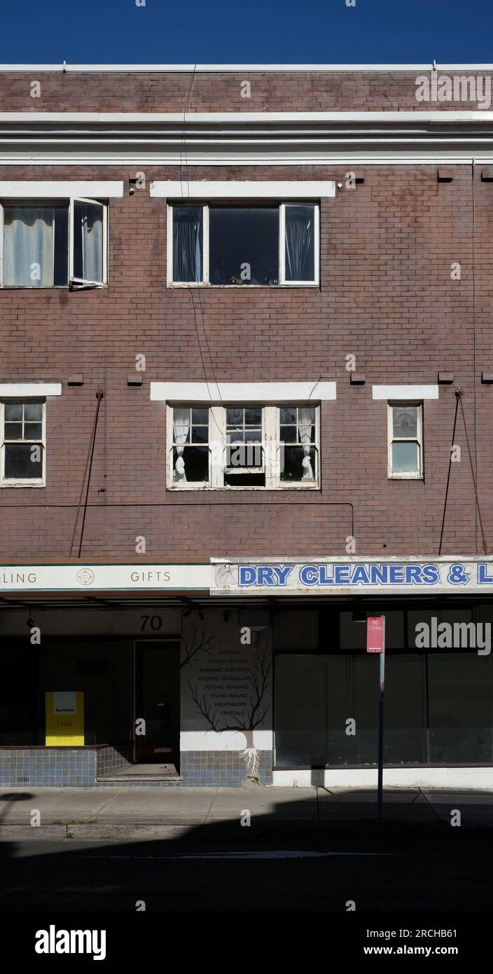 Vertical panorama of an old 2 story brown painted brick apart block on ...