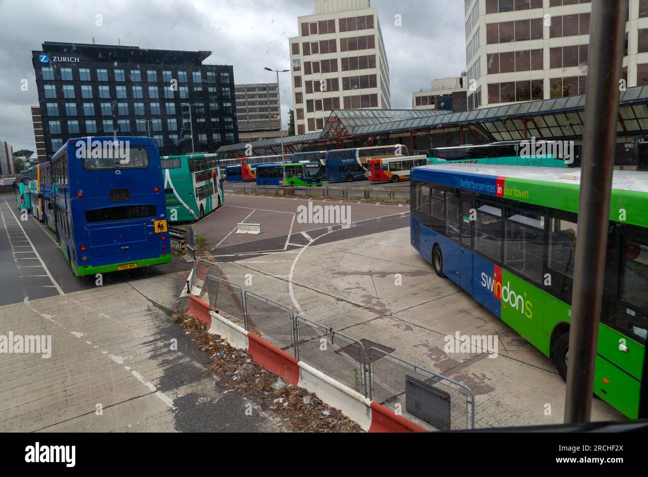 View through bus window of buses in bus station in the town centre ...