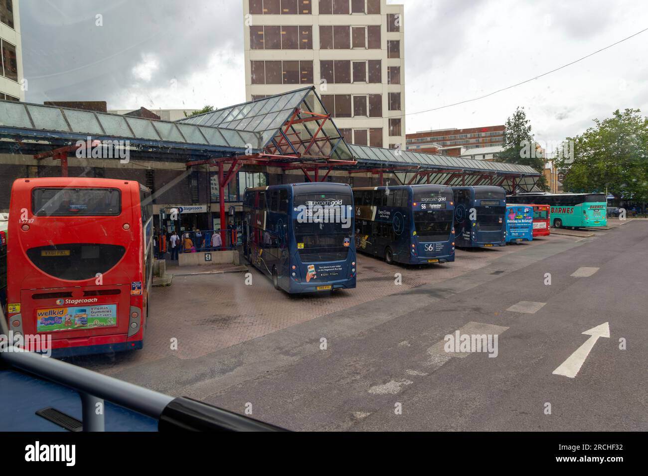 View through bus window of buses in bus station in the town centre ...