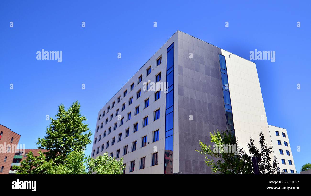 Fresh green trees and office building, business concept. Eco building ...