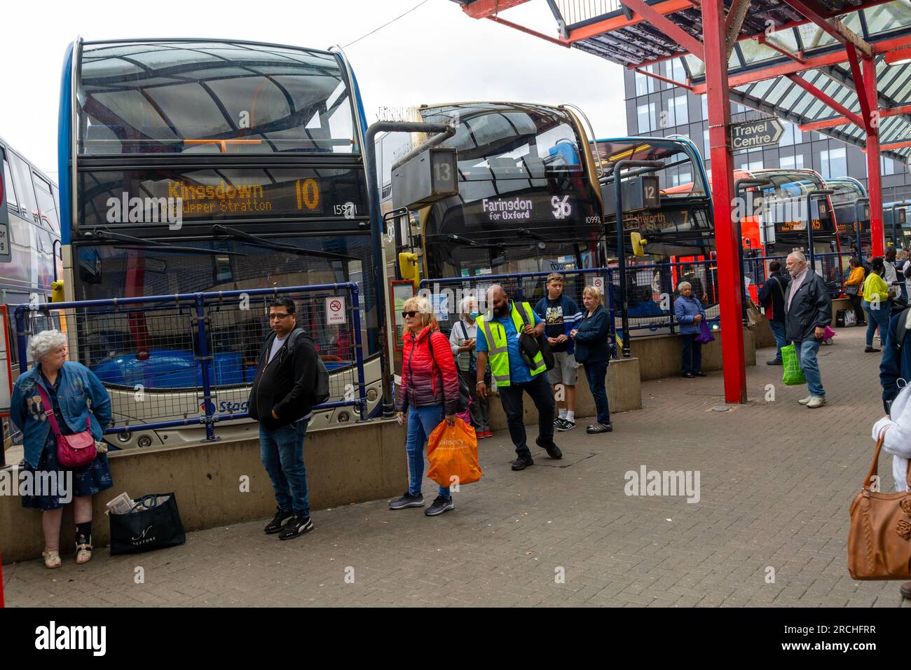People and buses in bus station in the town centre, Swindon, Wiltshire ...