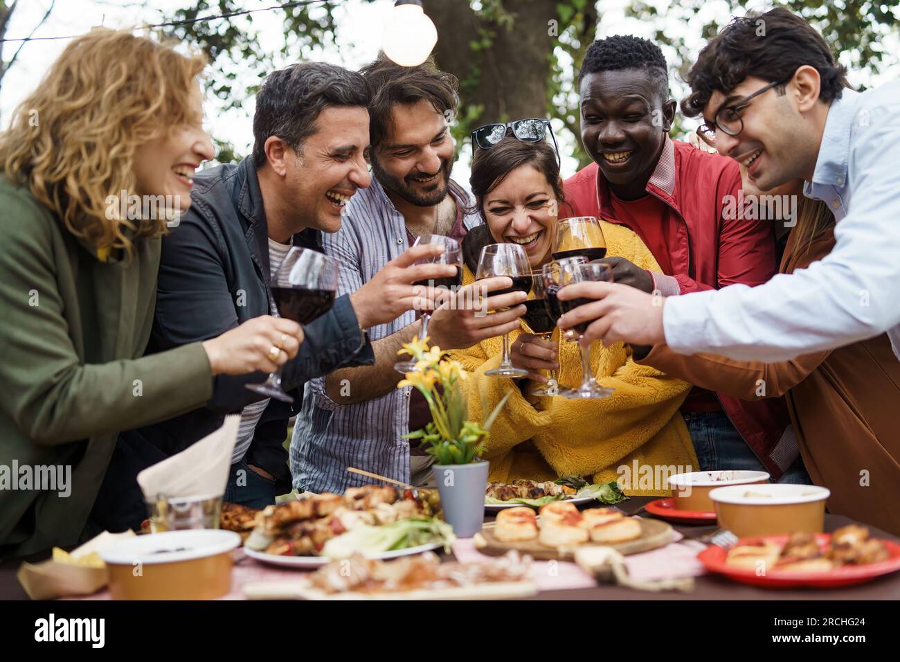 Friends standing around table hi-res stock photography and images - Alamy