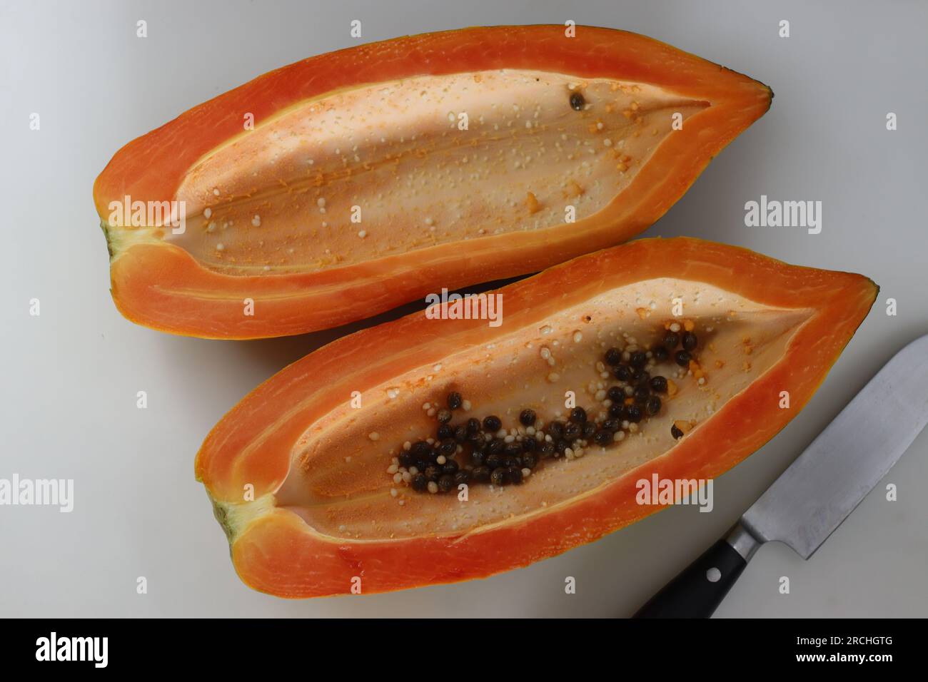 Ripe and ready to eat papaya slices. Long slices of ripe papaya with ...