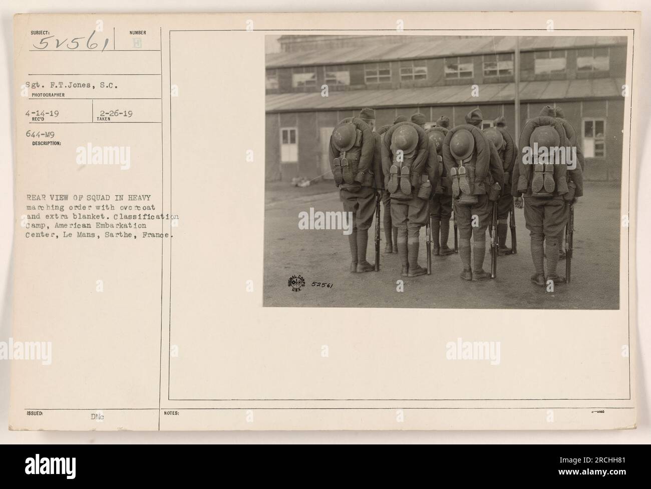 Rear view of a squad in heavy marching order with overcoat and extra ...