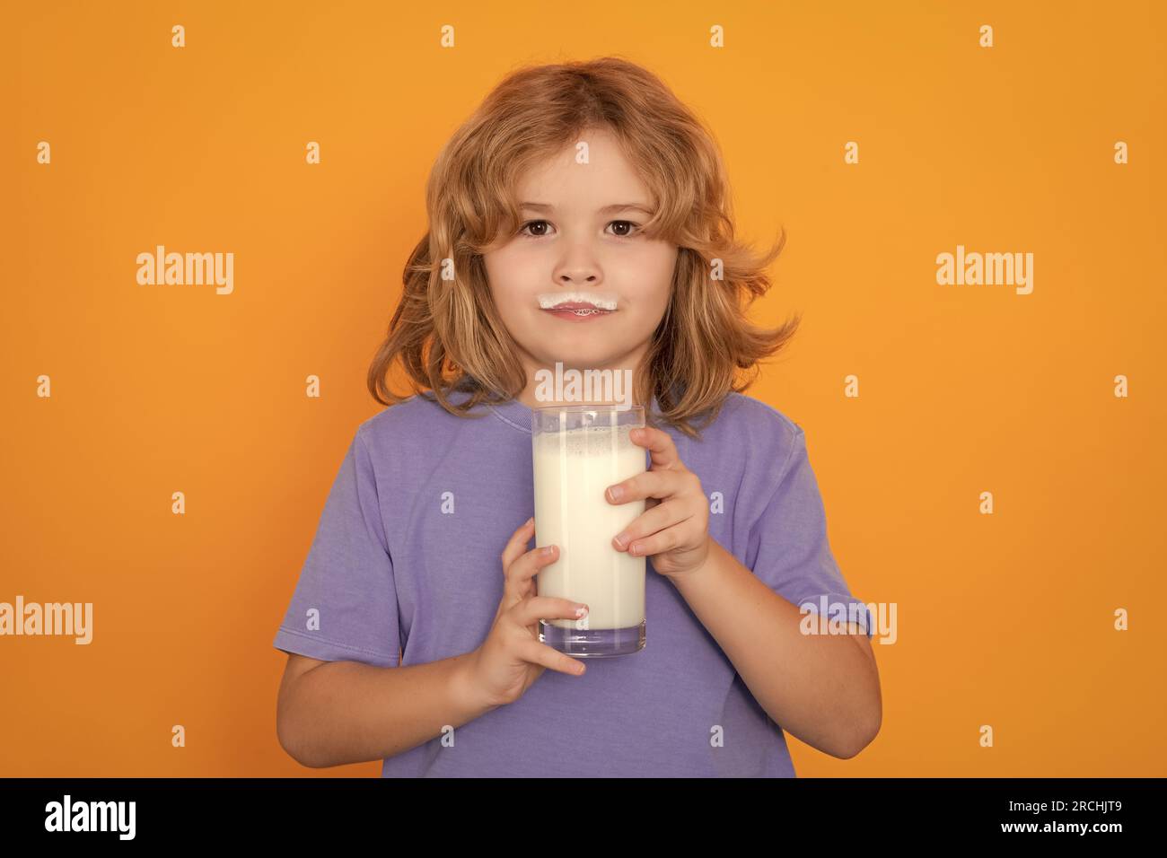 Healthy drink with calcium and protein for kids. Small boy drink a ...