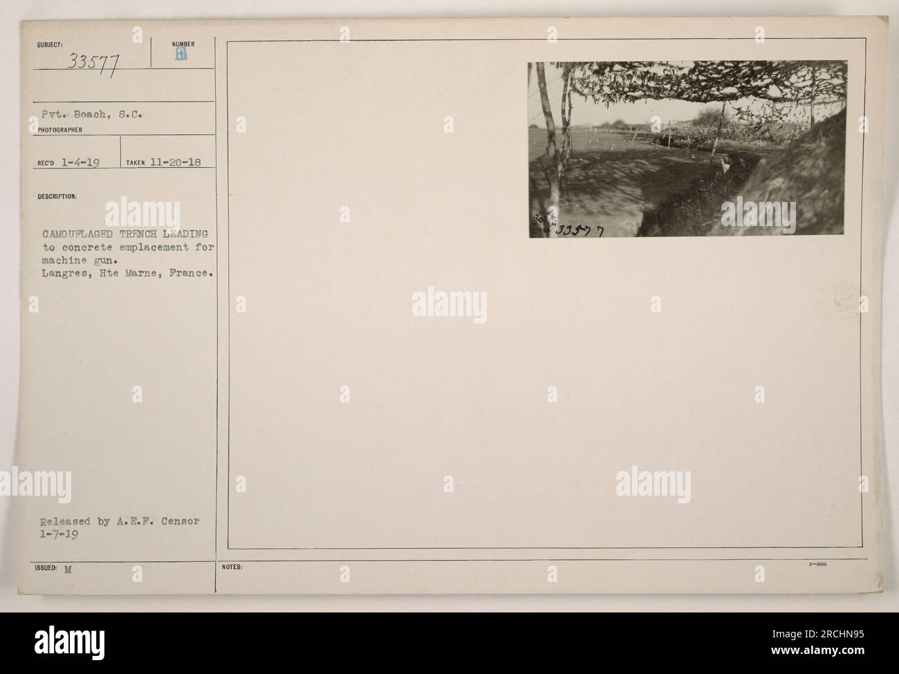 A photograph capturing a camouflaged trench leading to a concrete ...