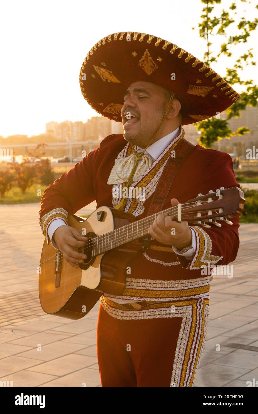 Mexican musician mariachi plays the guitar on a city street Stock Photo ...