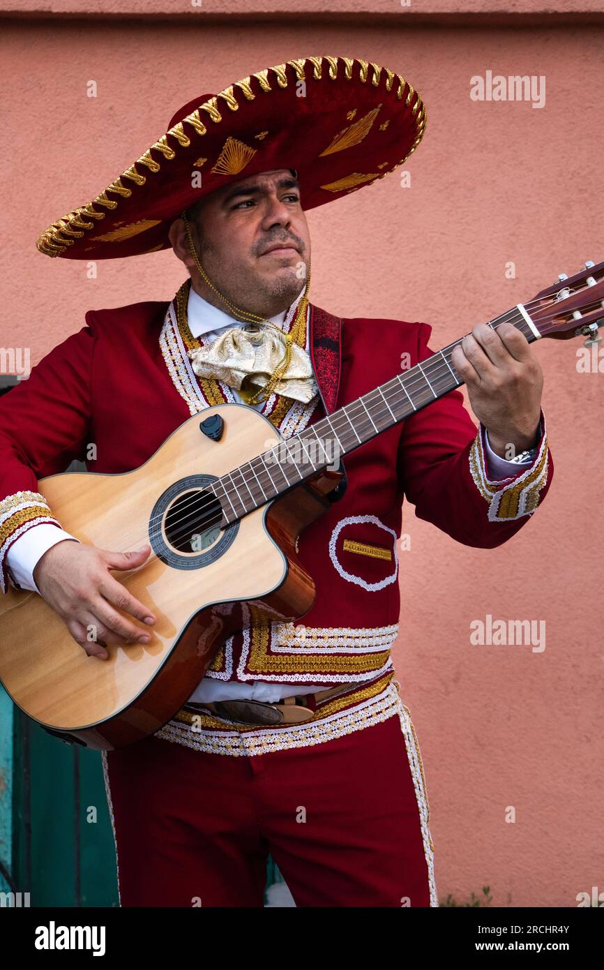 Mexican musician mariachi plays the guitar on a city street Stock Photo ...