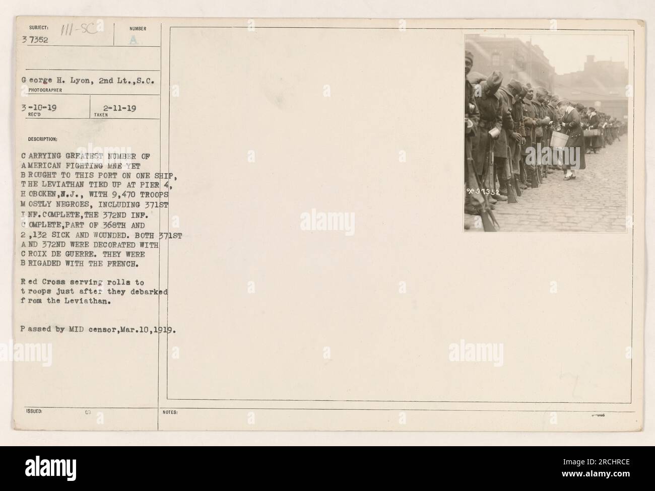 Caption: Red Cross serving rolls to troops just after debarking from ...