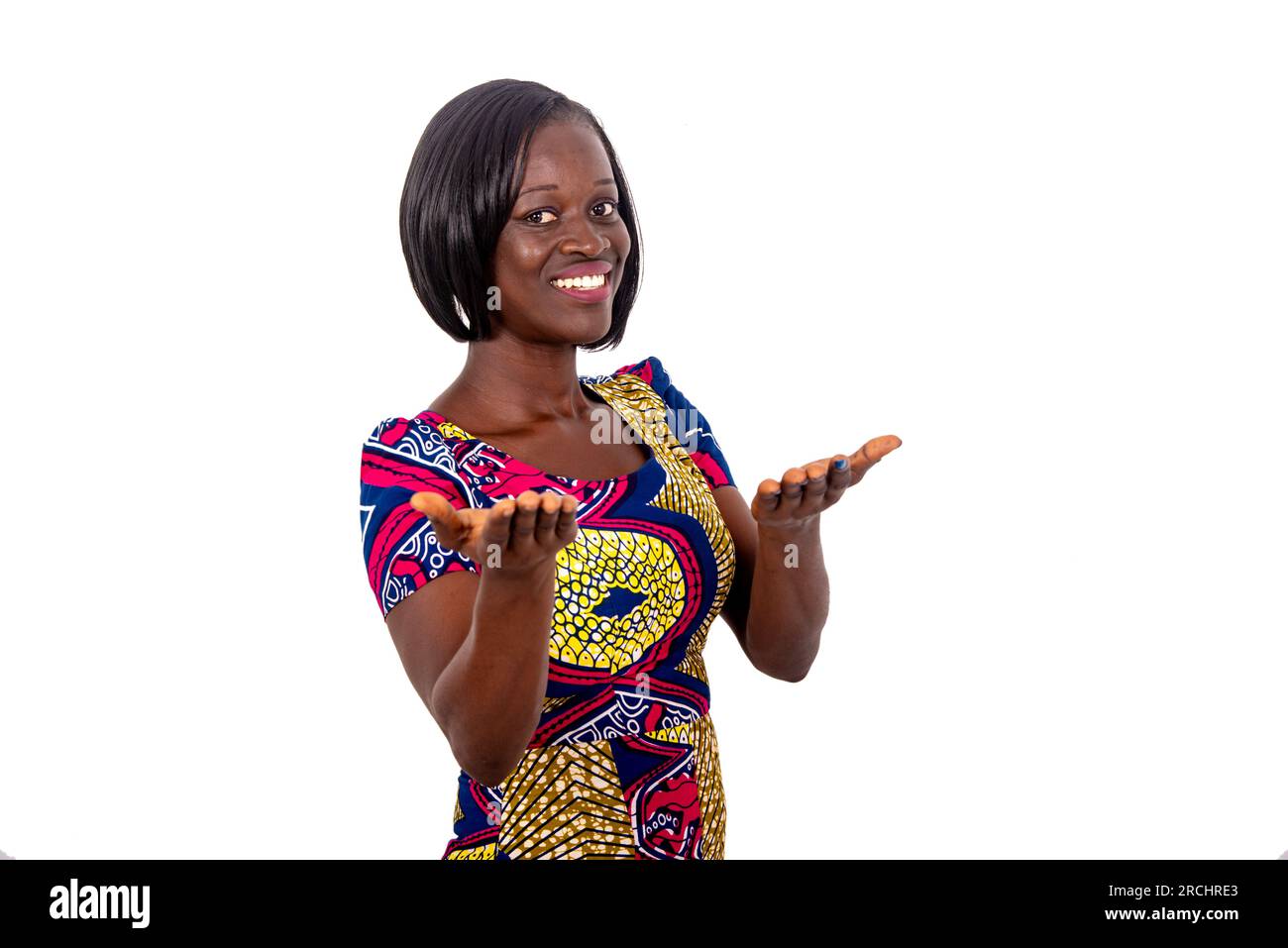 portrait of a beautiful happy young woman pointing both hands forward ...