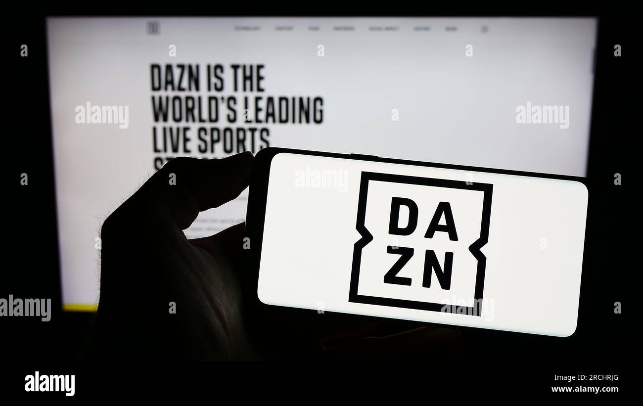 Person holding mobile phone with logo of British sports media company ...