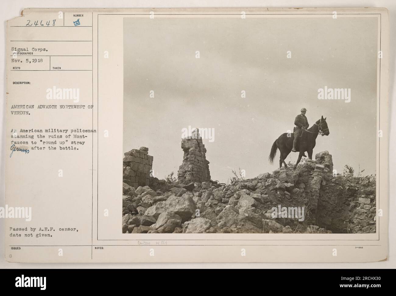 An American military policeman searches for stragglers among the ruins ...