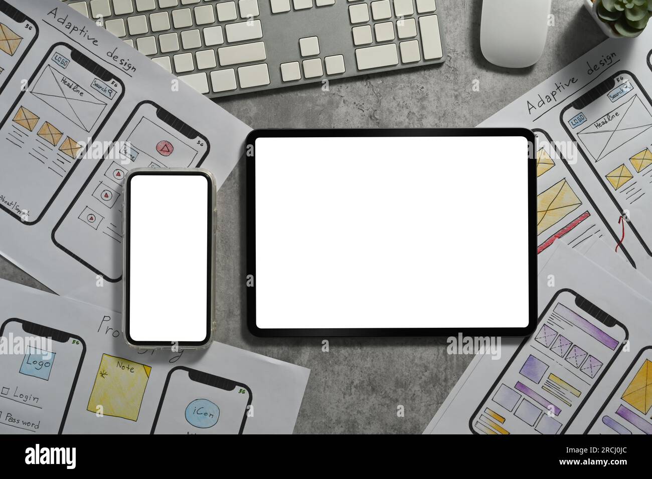 Smart phone and digital tablet with wireframe sketches of screens for ...