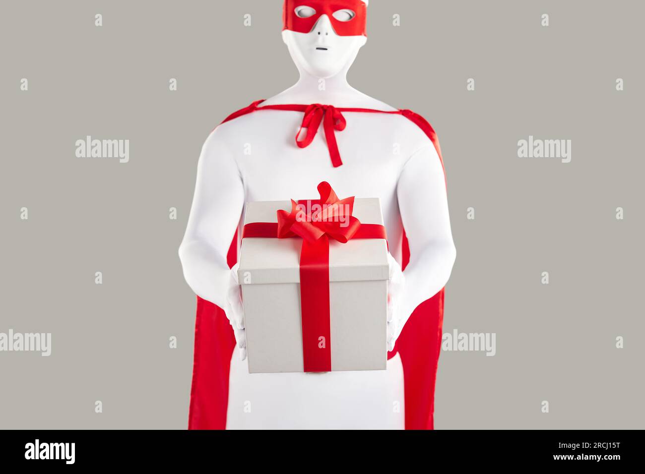 Man disguised in a superhero costume giving you a white present box ...