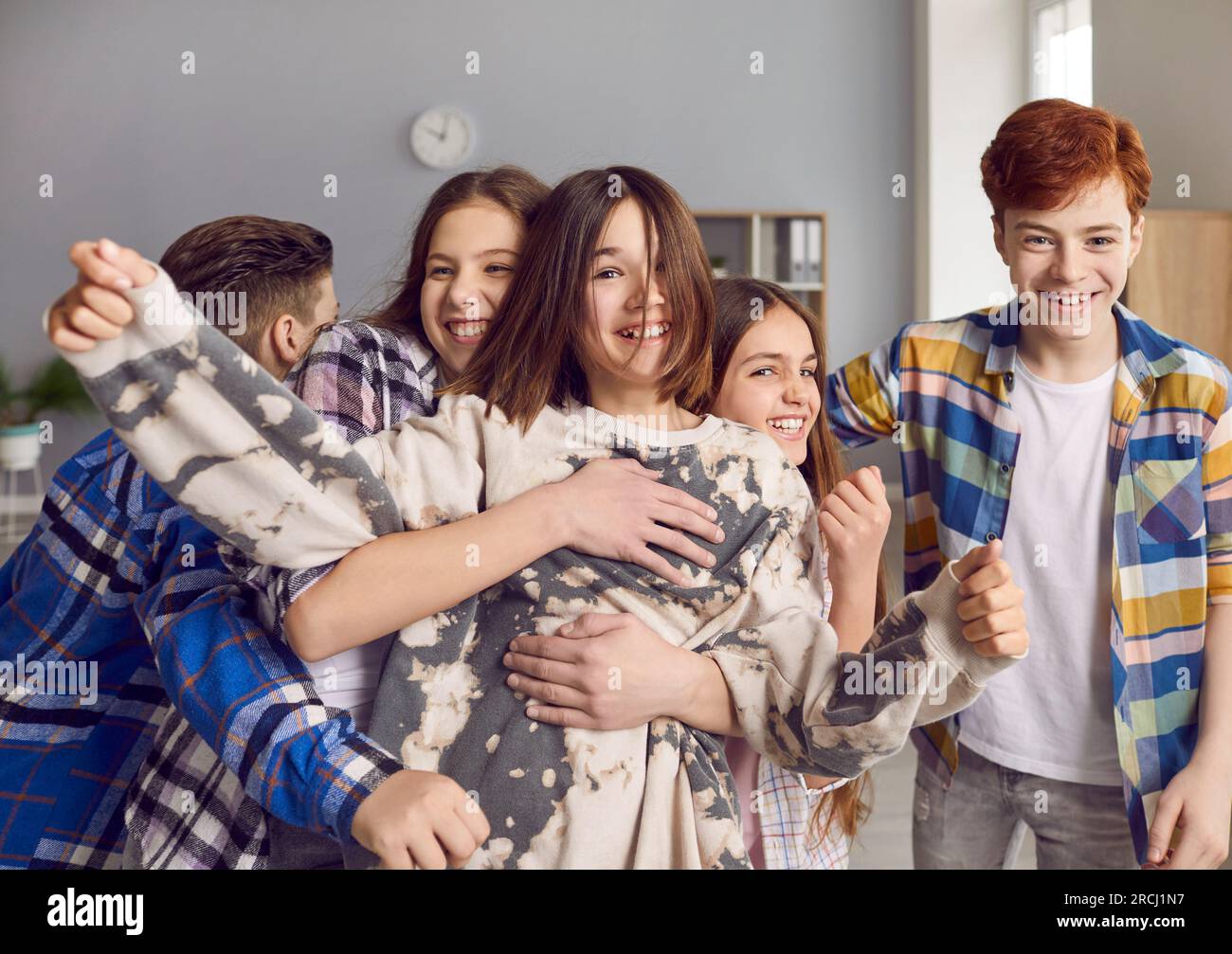 Group of happy, funny school friends playing, hugging, and having fun ...