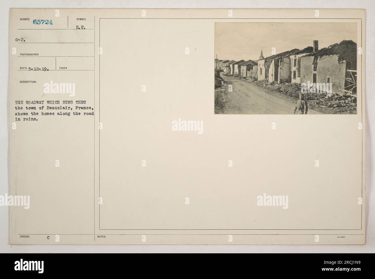 The image captures a road in the town of Beauclair, France during World ...