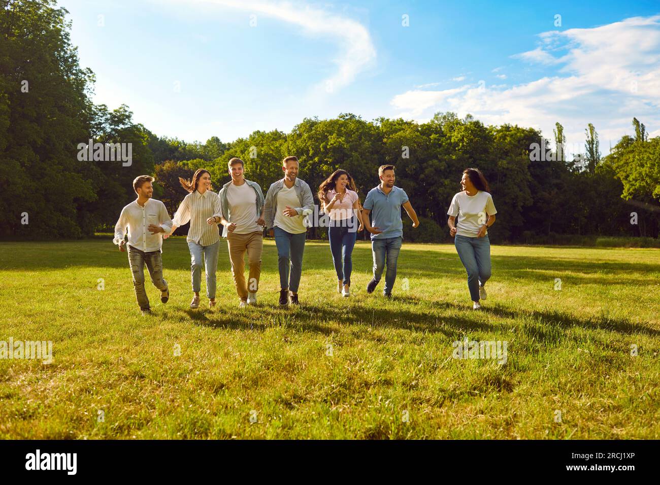 Group of a young happy smiling people friends students walking in the ...