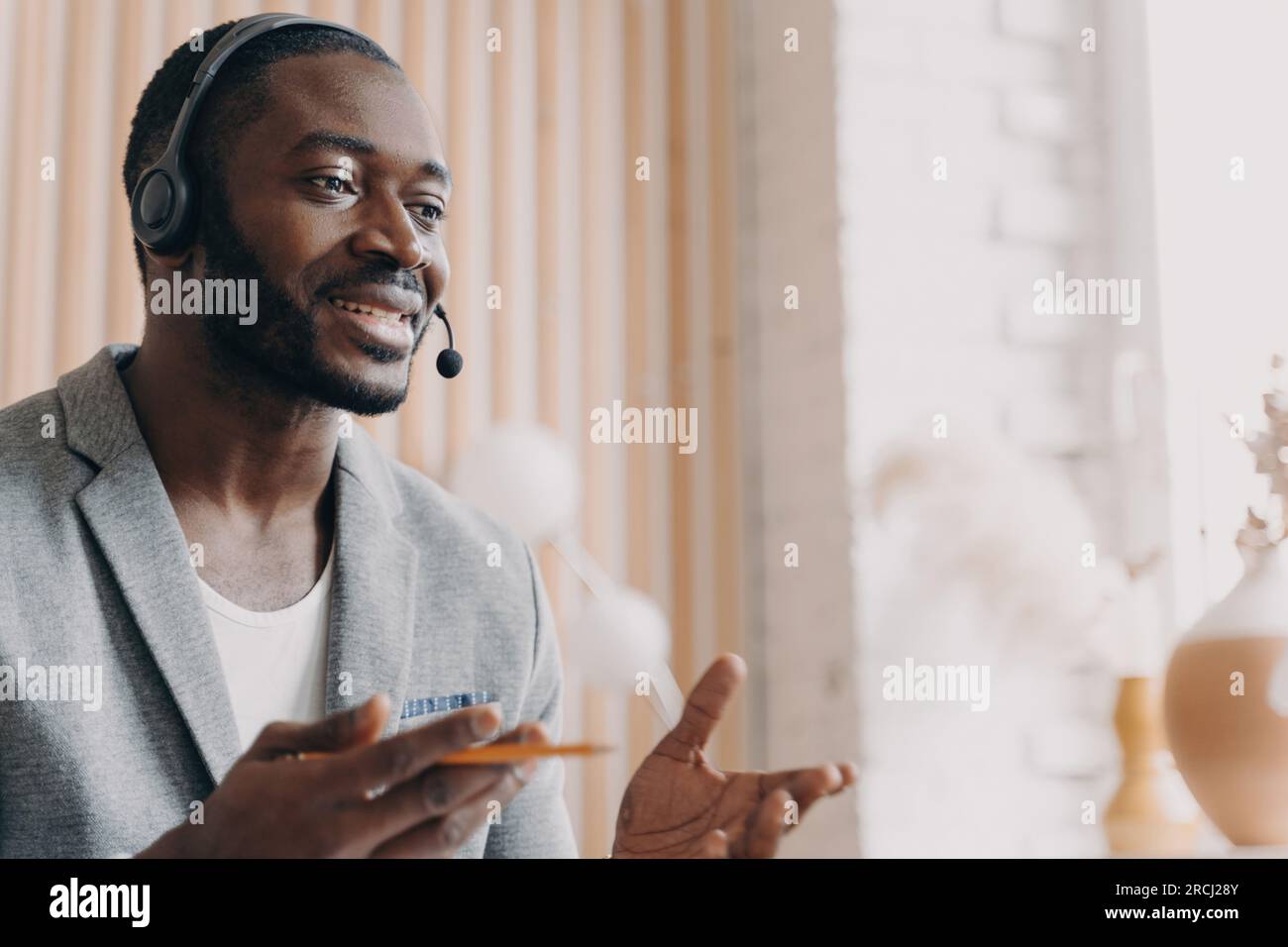 Handsome African American businessman, headset, video call, office ...