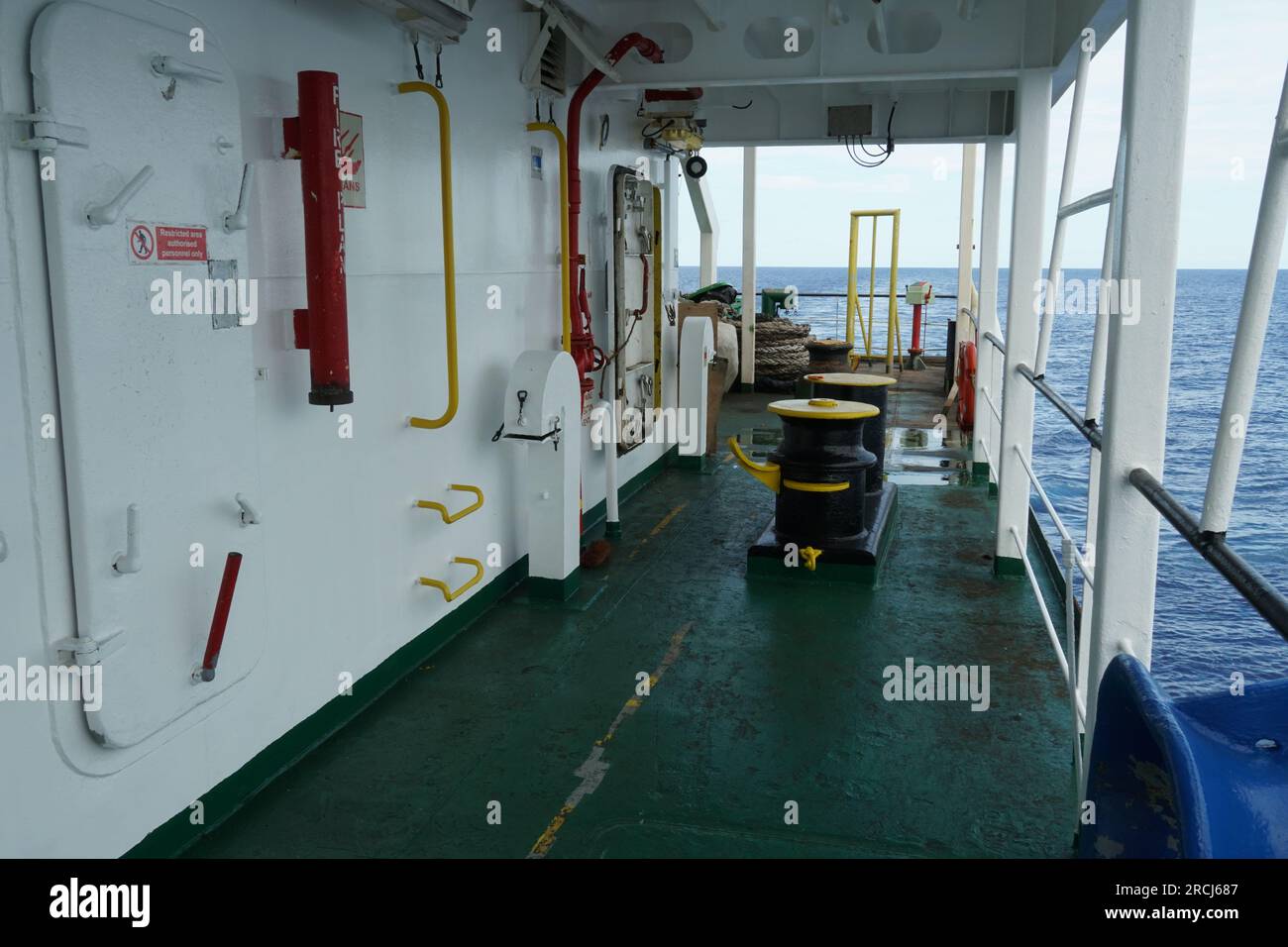 Entrance to white superstructure of container merchant vessel from main ...